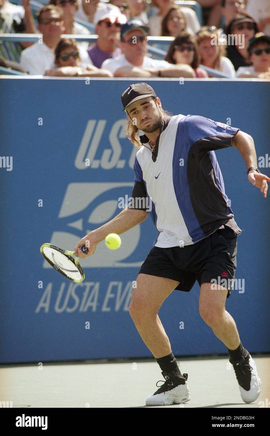 Andre Agassi of Las Vegas returns the ball to South Africa’s Wayne ...