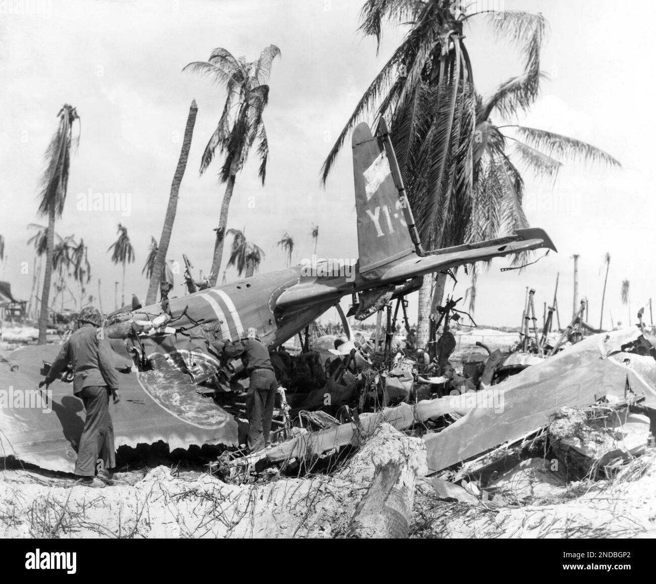 Marines examine the wreckage of a Japanese plane on Tarawa Island in ...