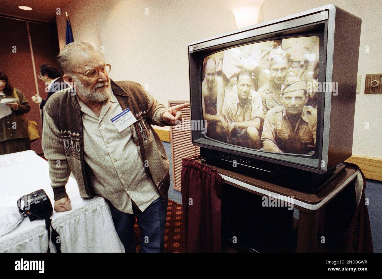 Former British intelligence agent Arthur Christie points to a film ...