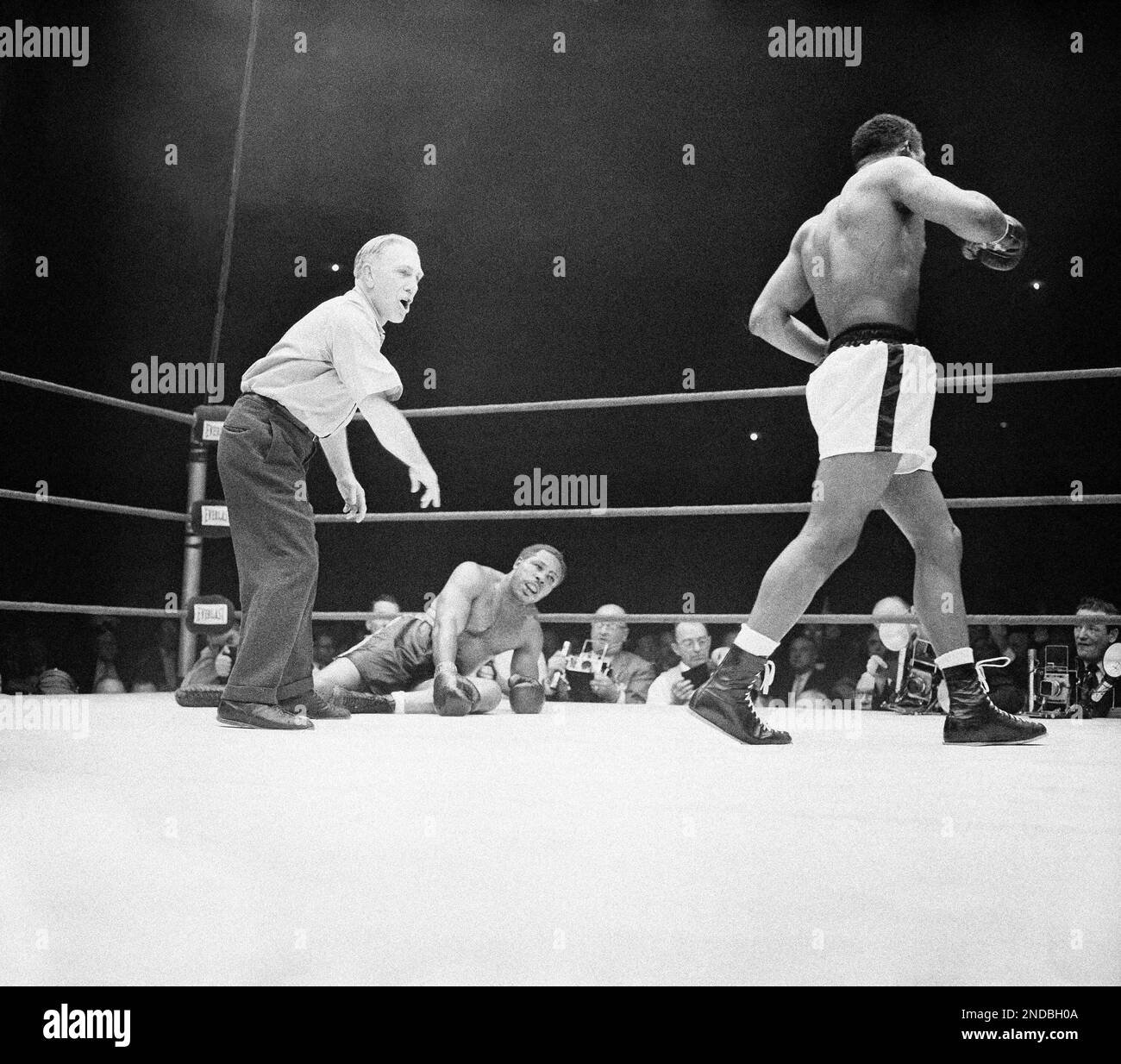 Archie Moore is driven to the canvas in the fifth round for the second ...