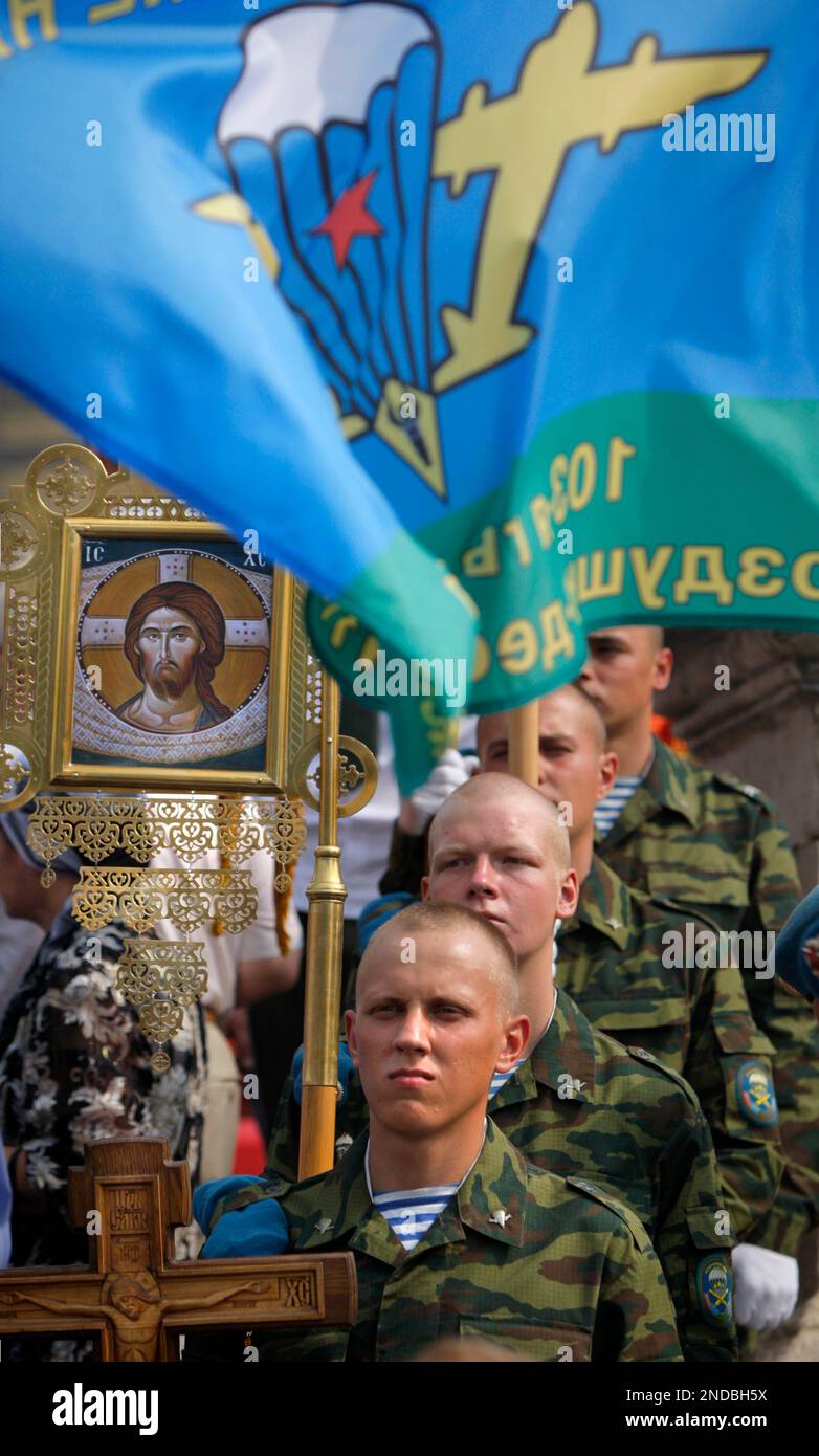 Russian paratroopers hold an icon and a paratrooper's flag celebrating ...