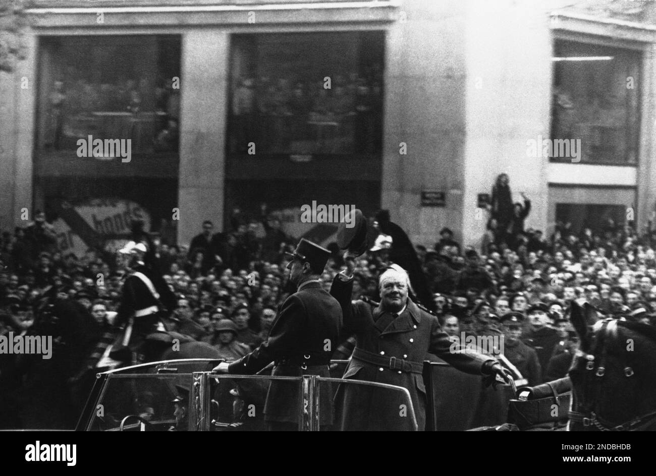 Britain's Prime Minister Winston Churchill waving to the cheering ...