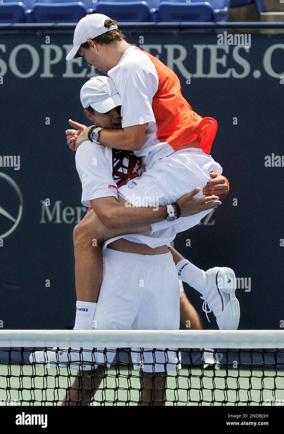 Mike Bryan, right, jumps into the arms of his brother Bob Bryan after ...