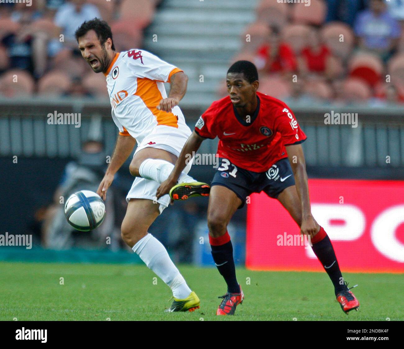 Joao Descesare Cicero, of AS Roma, left, is tackled by Adama Toure, of ...