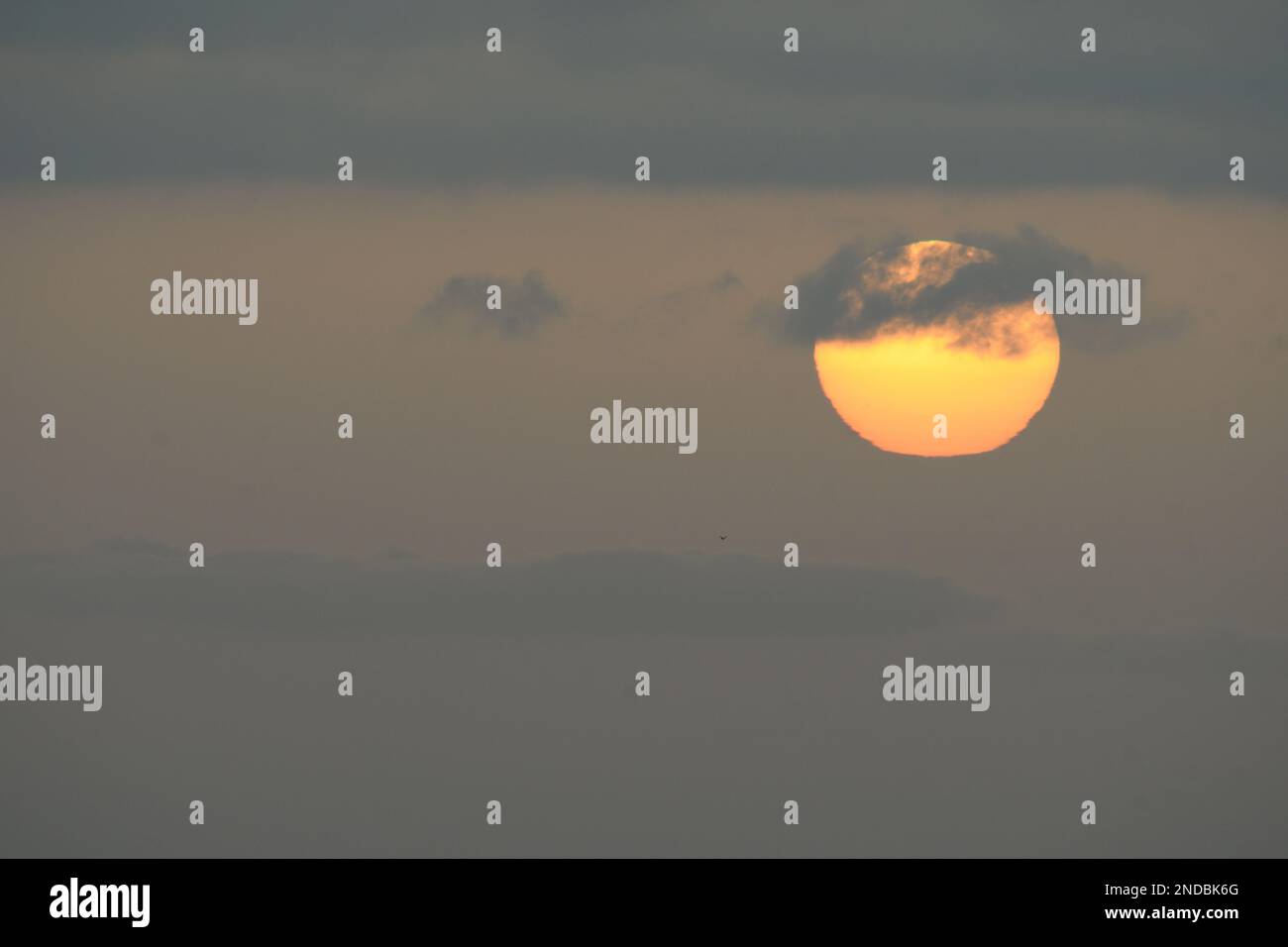 Sun between clouds at dawn in Fuerteventura Stock Photo - Alamy