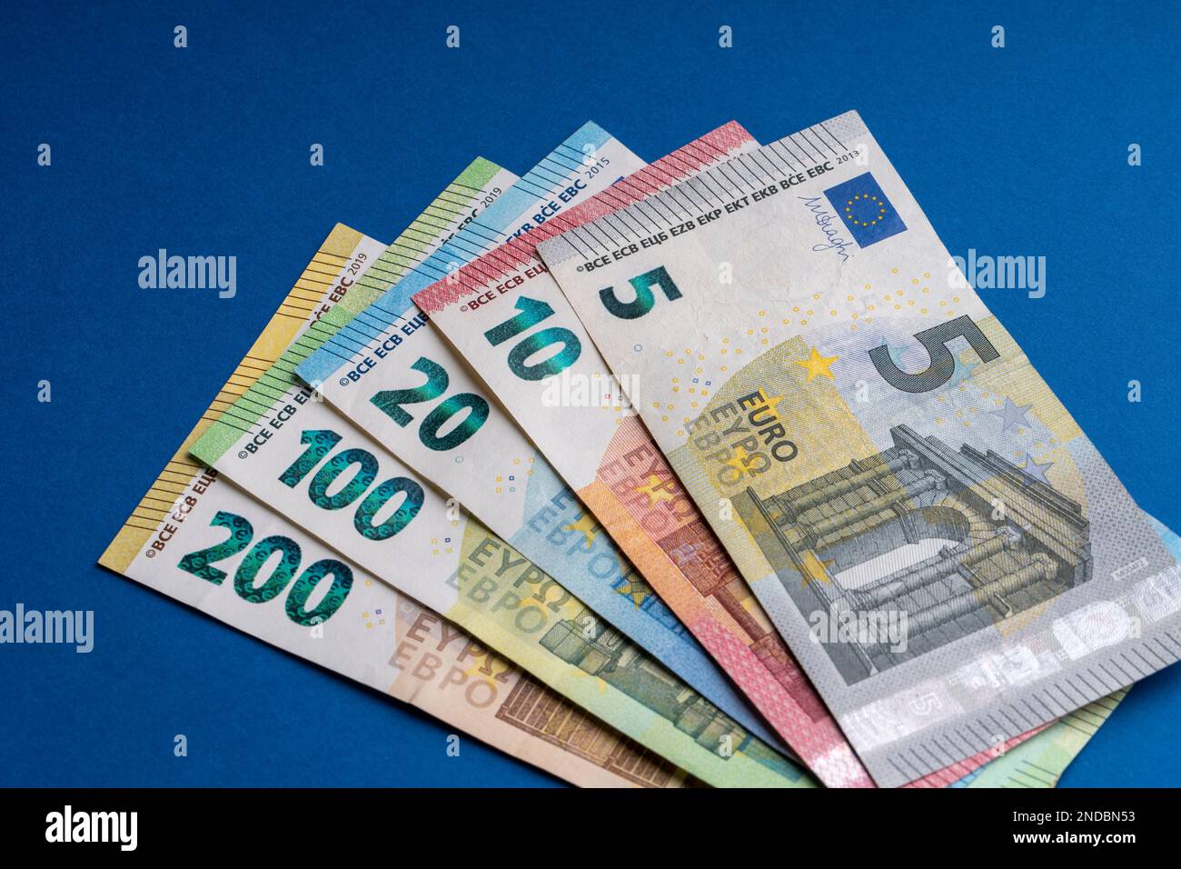 Different euro banknotes in a row close up, blue background for ...