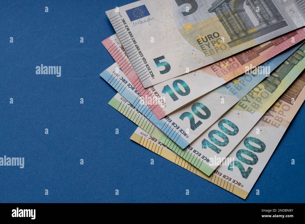 Different euro banknotes in a row close up, blue background for ...