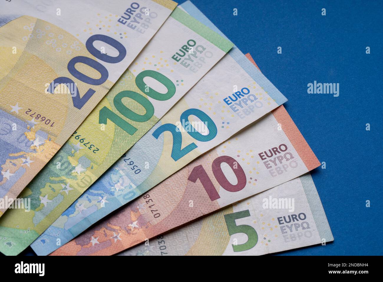Different euro banknotes in a row close up, blue background for ...