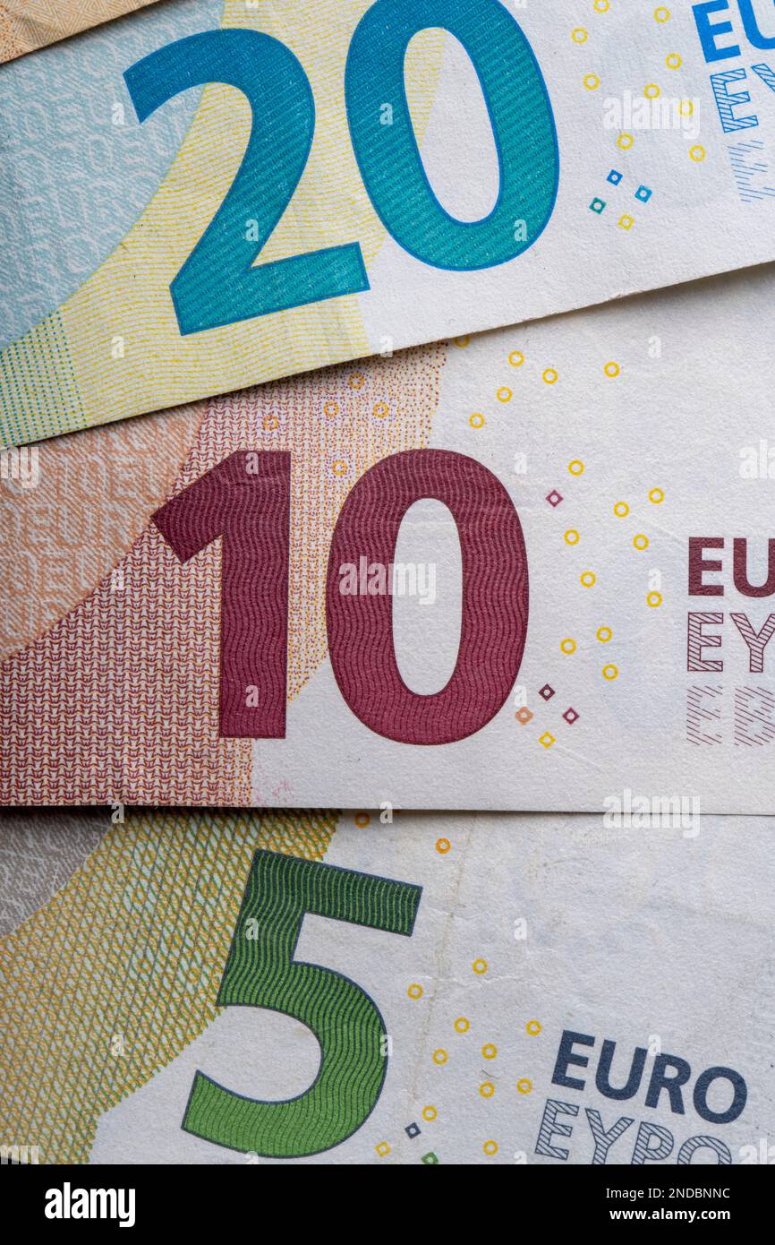 Different euro banknotes in a row close up, blue background for ...