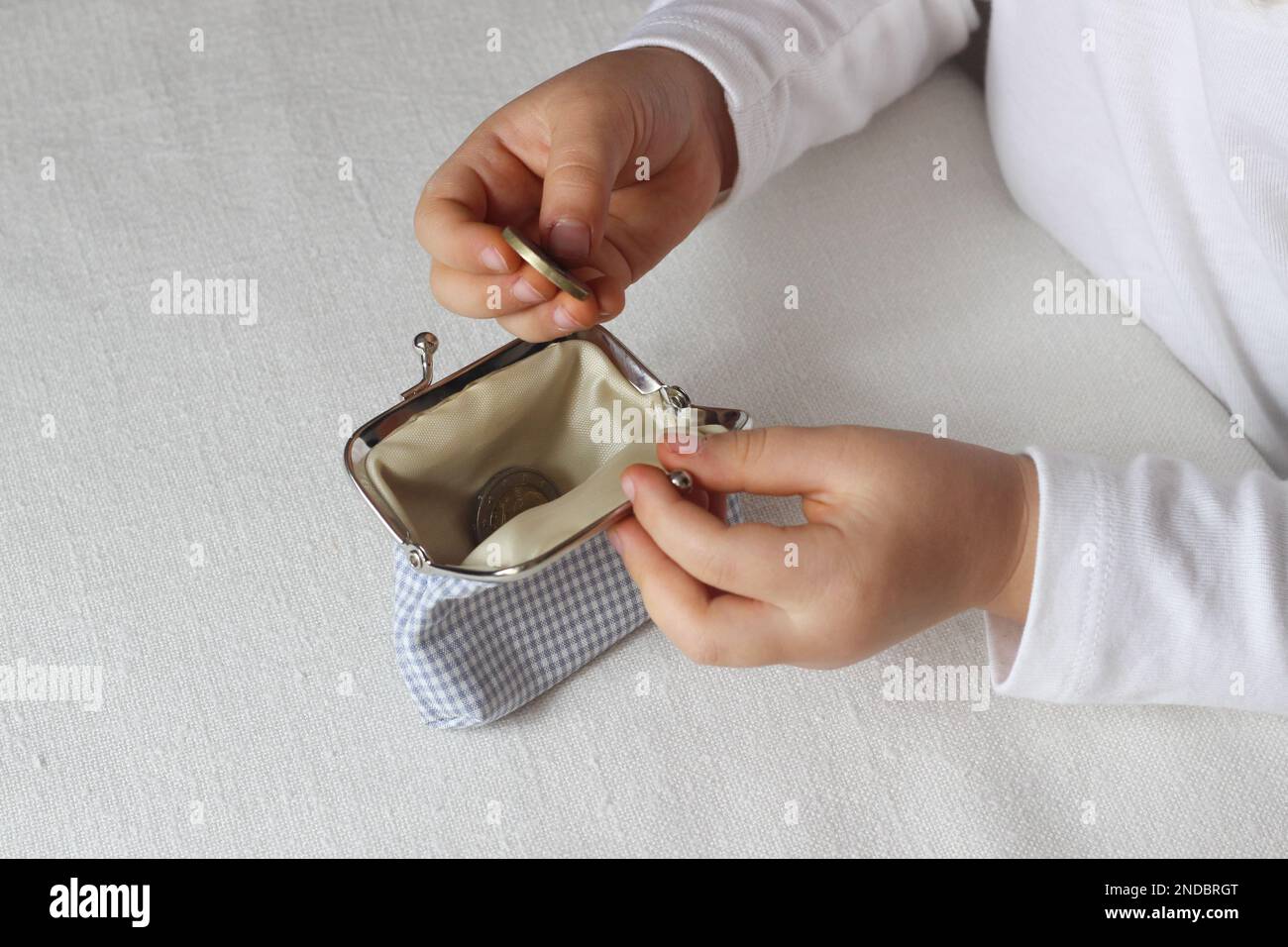 Kids hands put coins in a wallet,toddler girl with money and pusre in ...