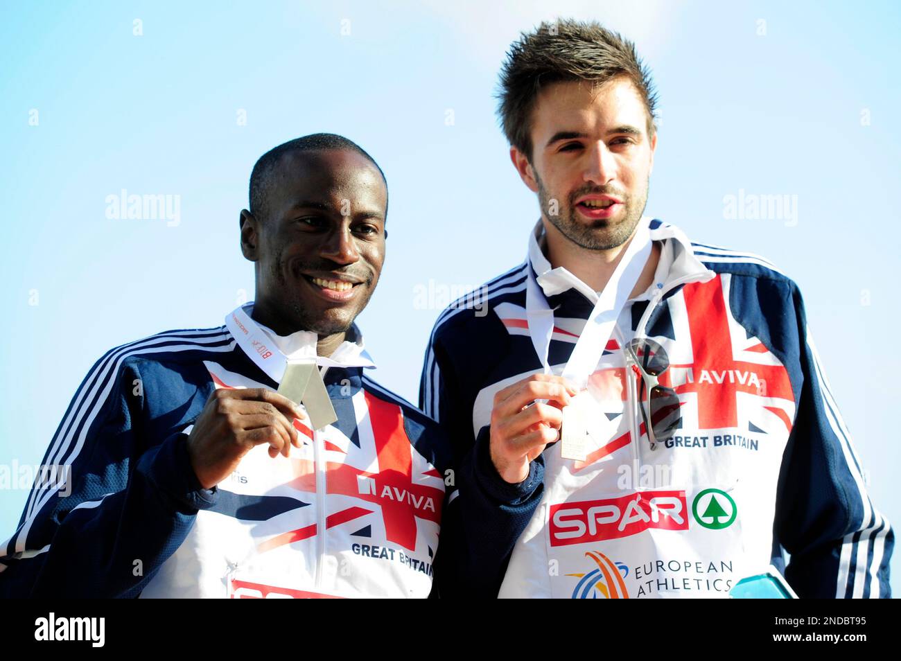 Britain's Michael Bingham, left, poses with his silver medal next to ...