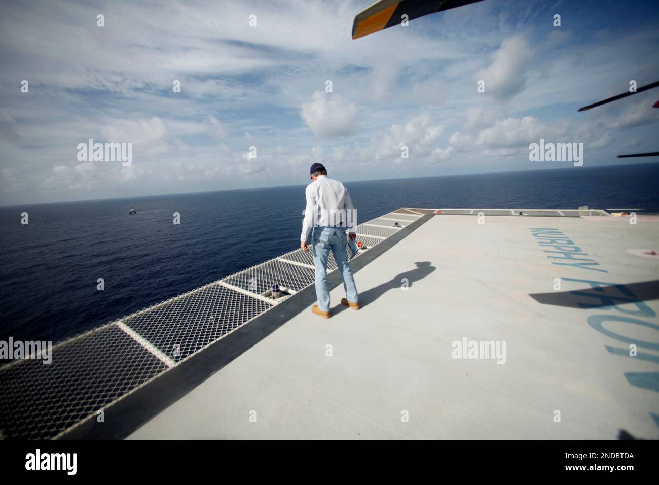 Interior Secretary Ken Salazar looks off the helo pad into the waters ...