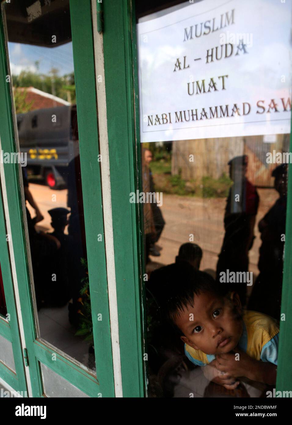 In this photo taken on Friday, July 30, 2010, a boy looks out from a ...
