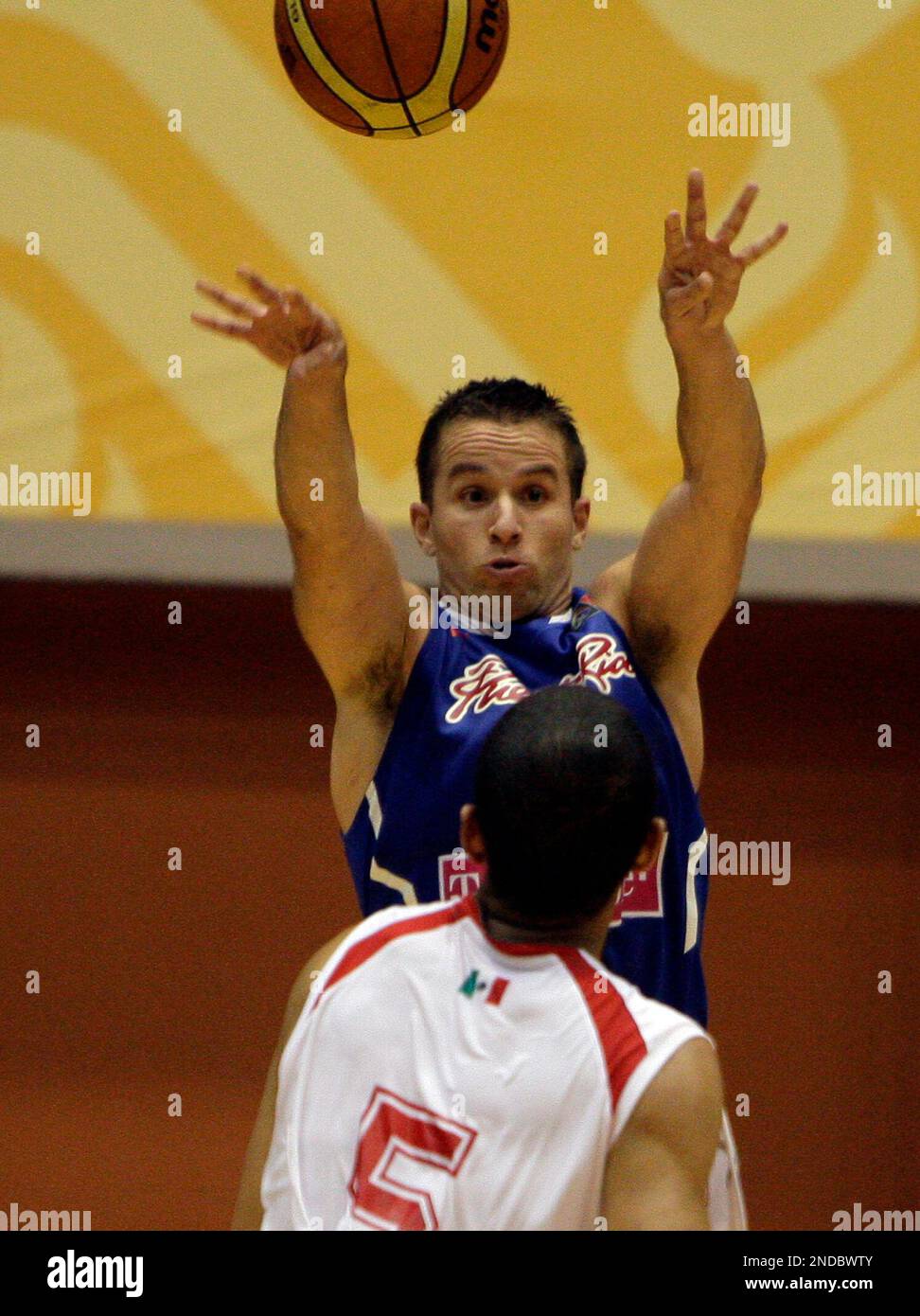 Puerto Rico's Jose Juan Barea, top, passes the ball over Mexico's Jovan ...