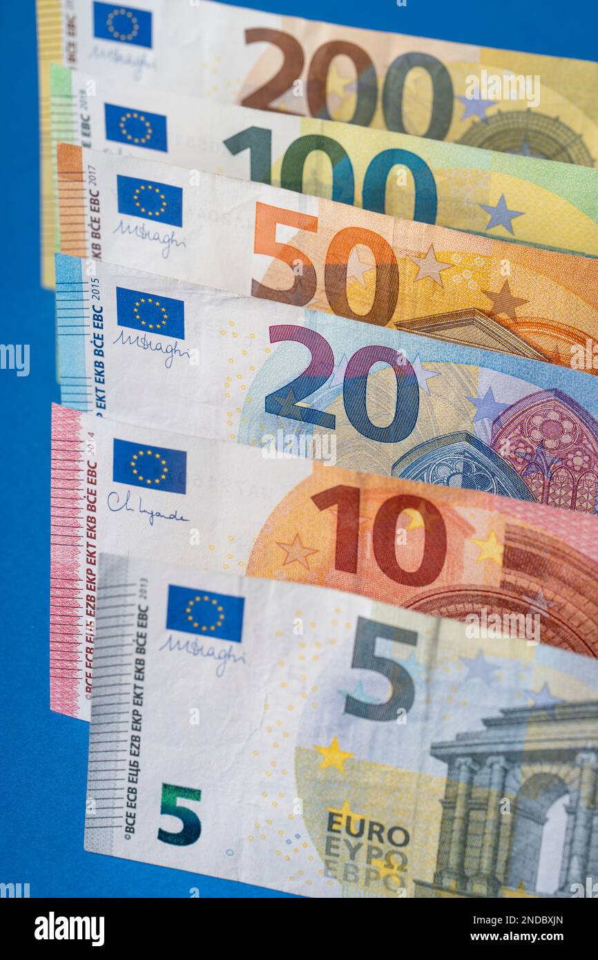 Different euro banknotes in a row close up, blue background for ...