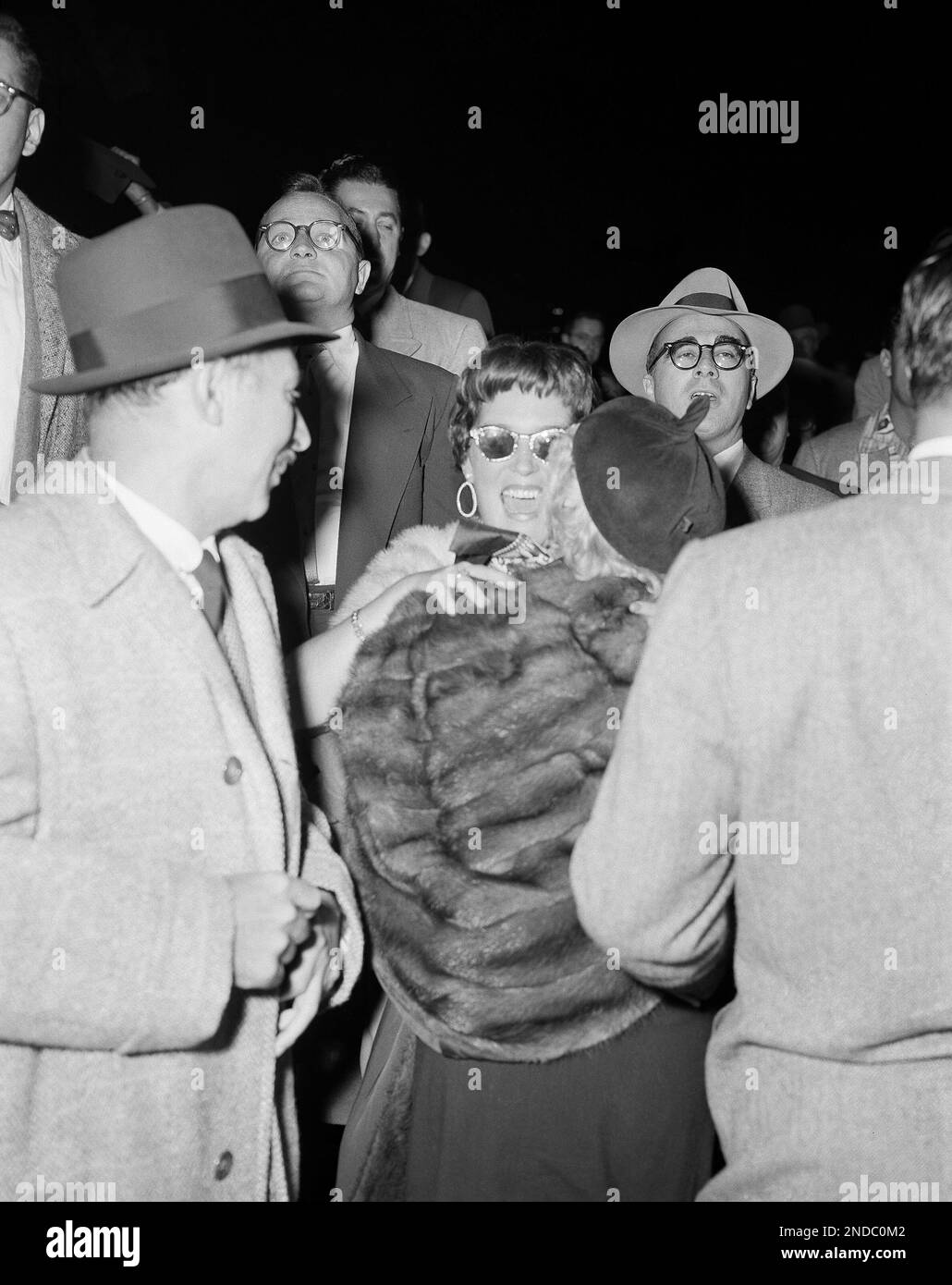 Mrs.Barbara Marciano, dark glasses, shouts her joy and hugs a friend ...