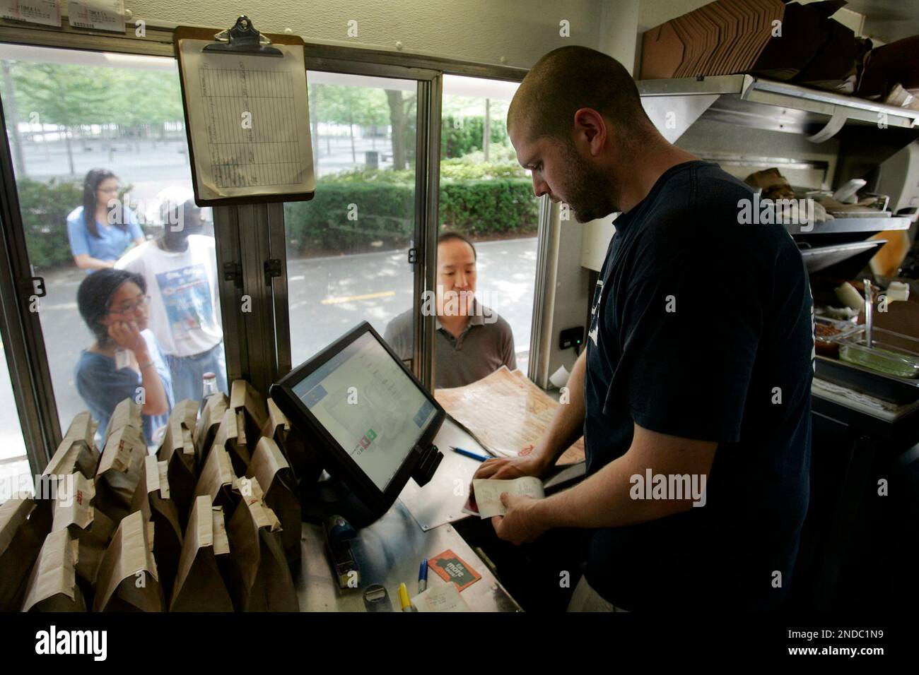 Truck manager Steven Ostroth takes a food order on The Taco Truck in ...