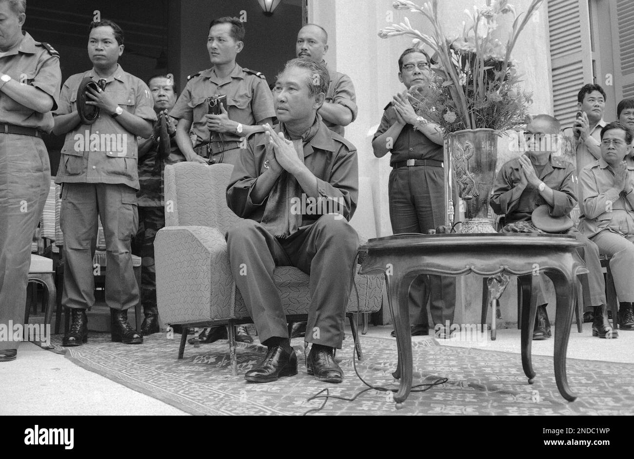Hands together in prayer, Cambodian President Lon Nol and his staff ...