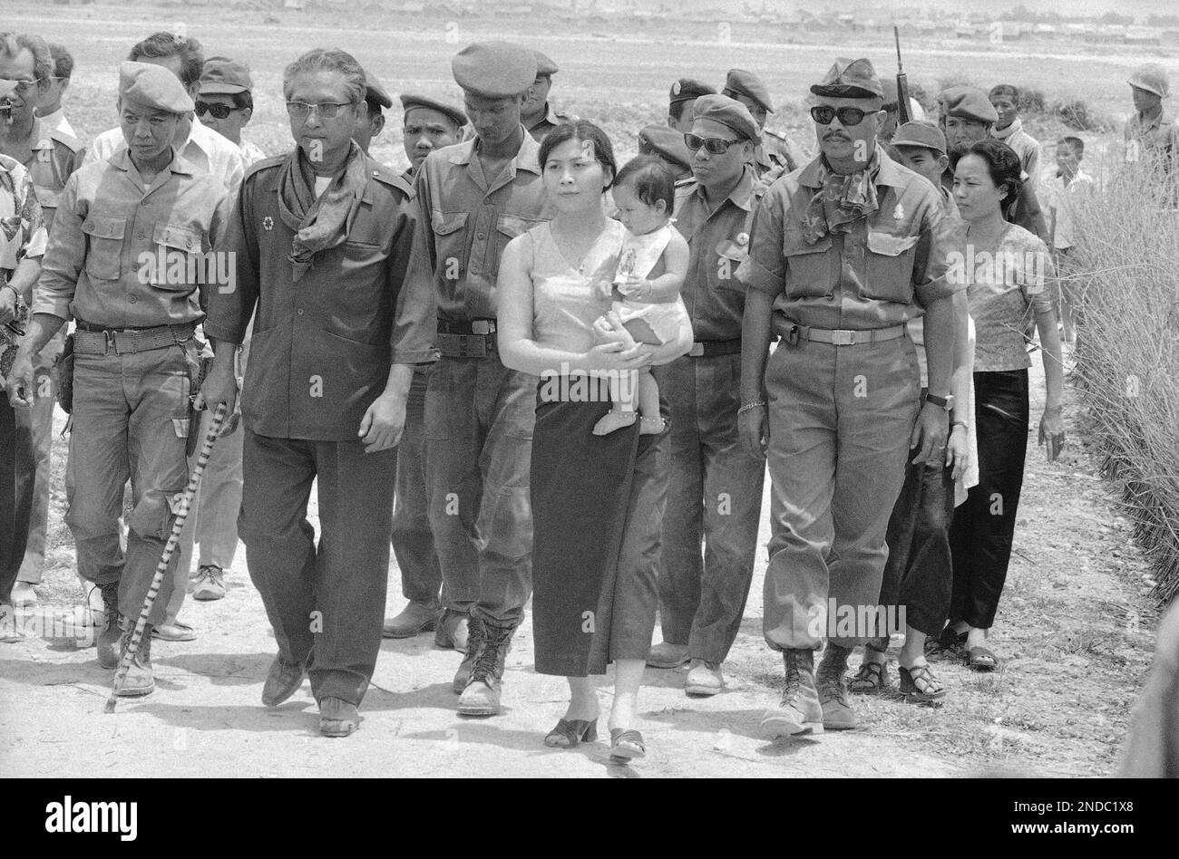 Cambodian President Lon Nol (with cane) is engulfed by army of officers ...
