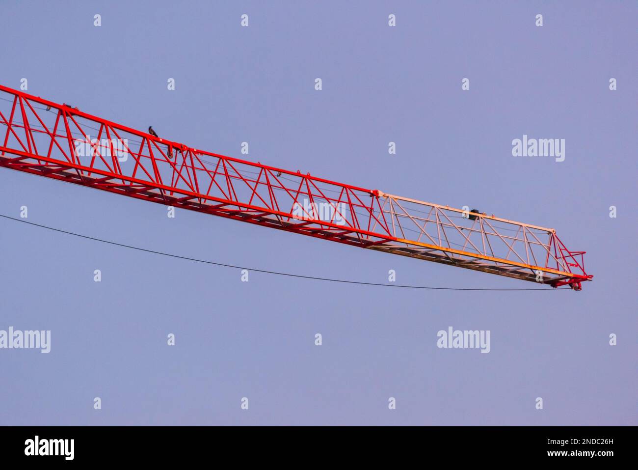 Red and white boom of a construction crane Stock Photo - Alamy
