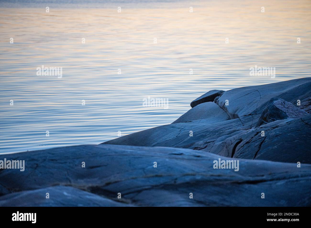 Rounded cliffs by the sea at late night Stock Photo - Alamy