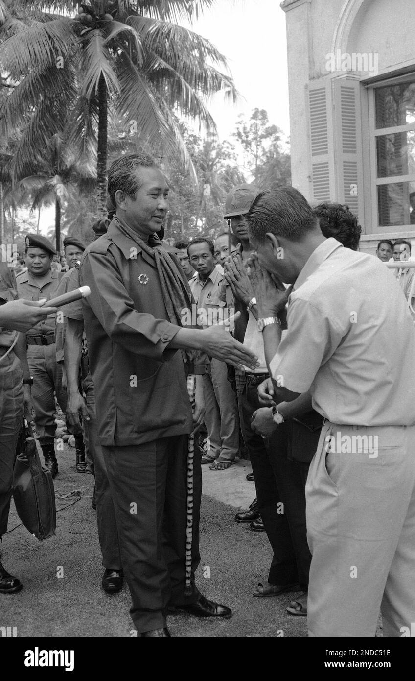 Cambodian President Lon Nol is extending his hand to Kampot well-wisher ...