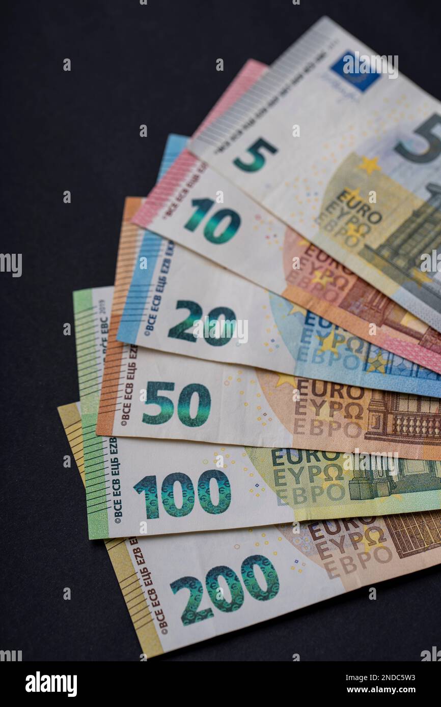 Different euro banknotes in a row close up, black background for ...
