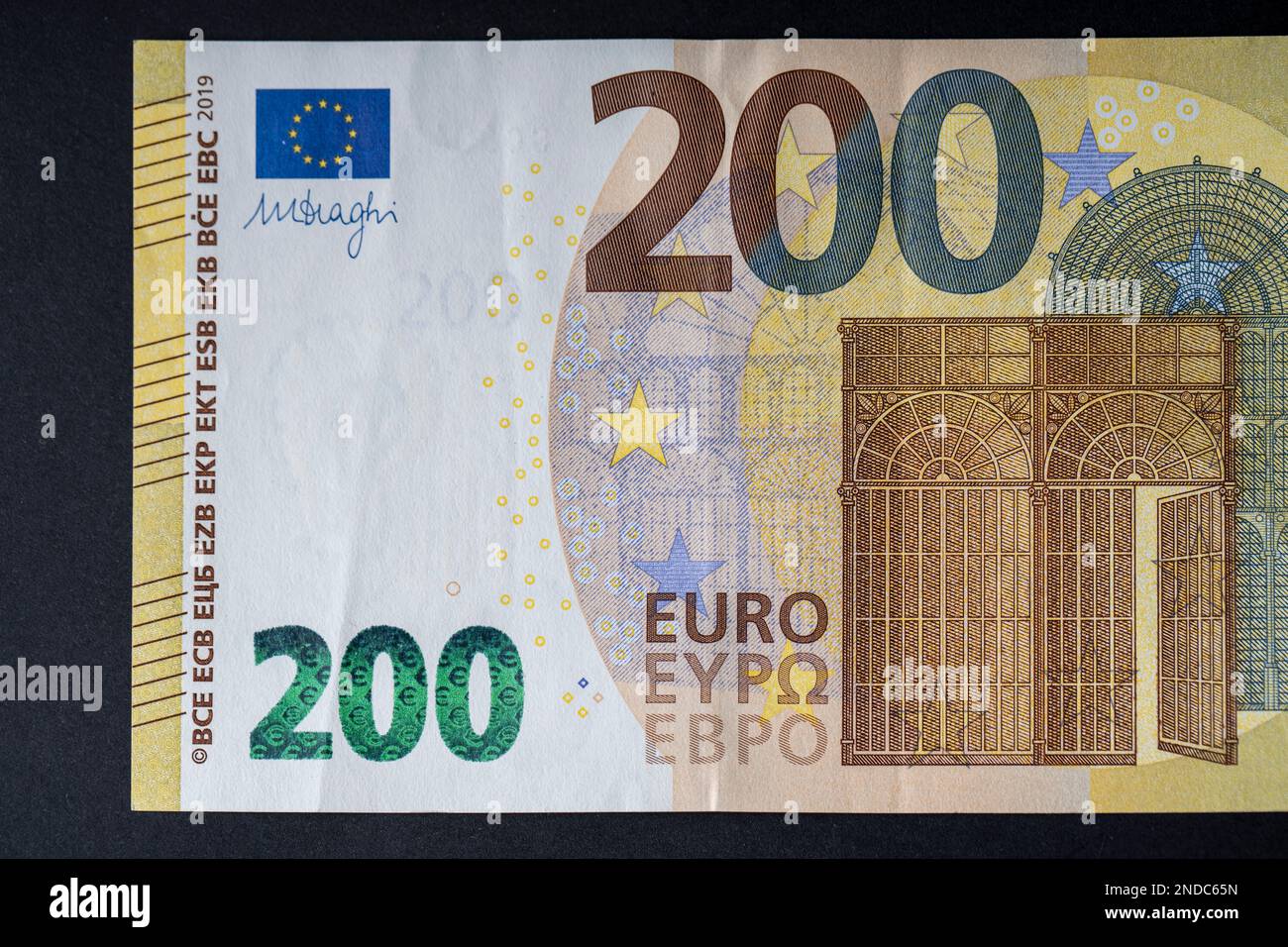200 euro banknote close up on black background for business finance ...