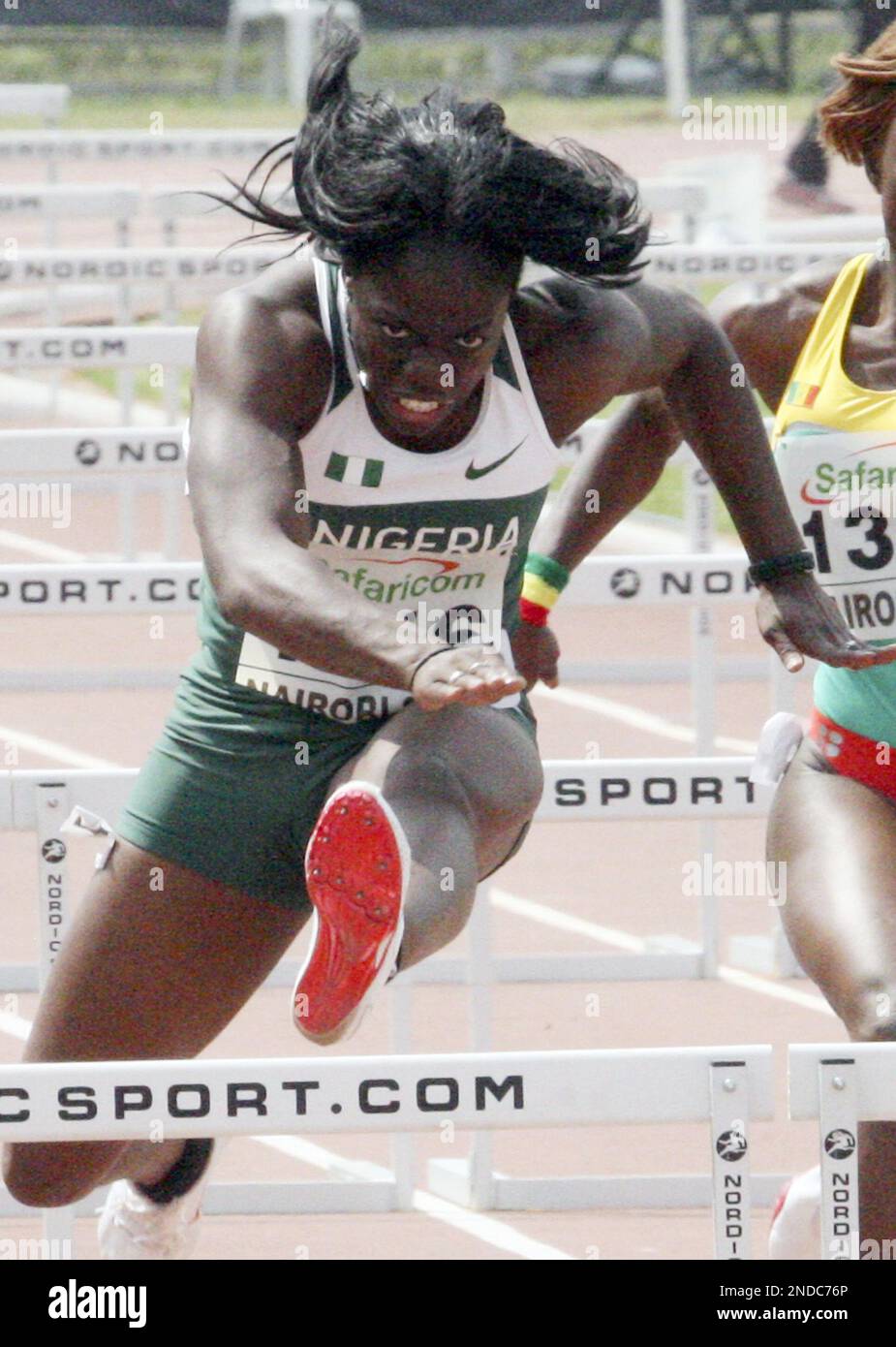 Seun Adigun of Nigeria, clears the hurdle as she goes on to win win ...