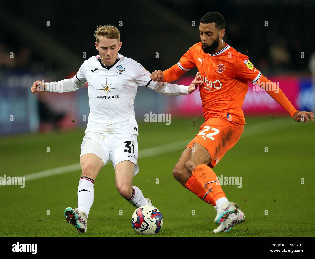 Swansea City's Oli Cooper (left) and Blackpool's CJ Hamilton battle for ...