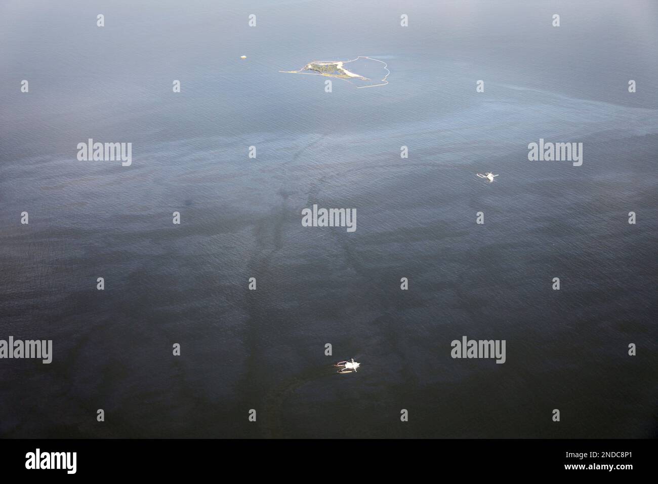 Skimming vessels are seen amongst a large stretch of oil from the ...