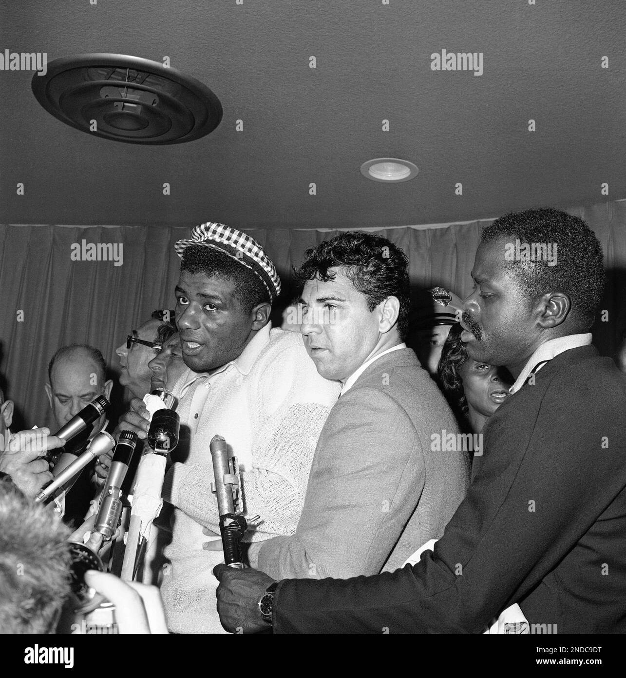 Floyd Patterson, appearing almost too tired to stand, tells newsmen in ...
