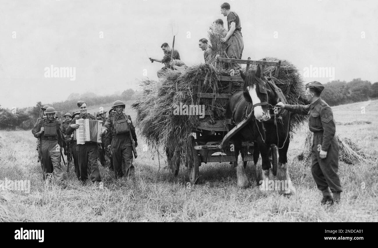 Led by an accordion player, British soldiers in uniform march into a ...