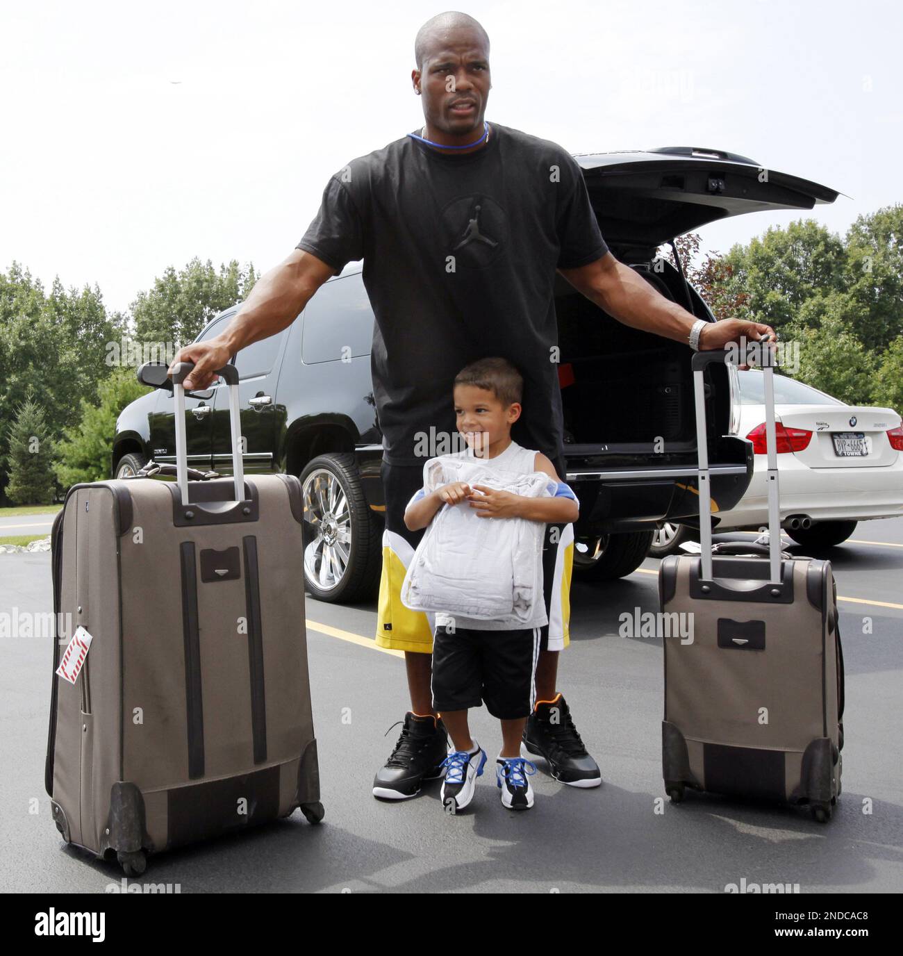 Buffalo Bills' Fred Jackson walks with his son Braeden as they arrive ...