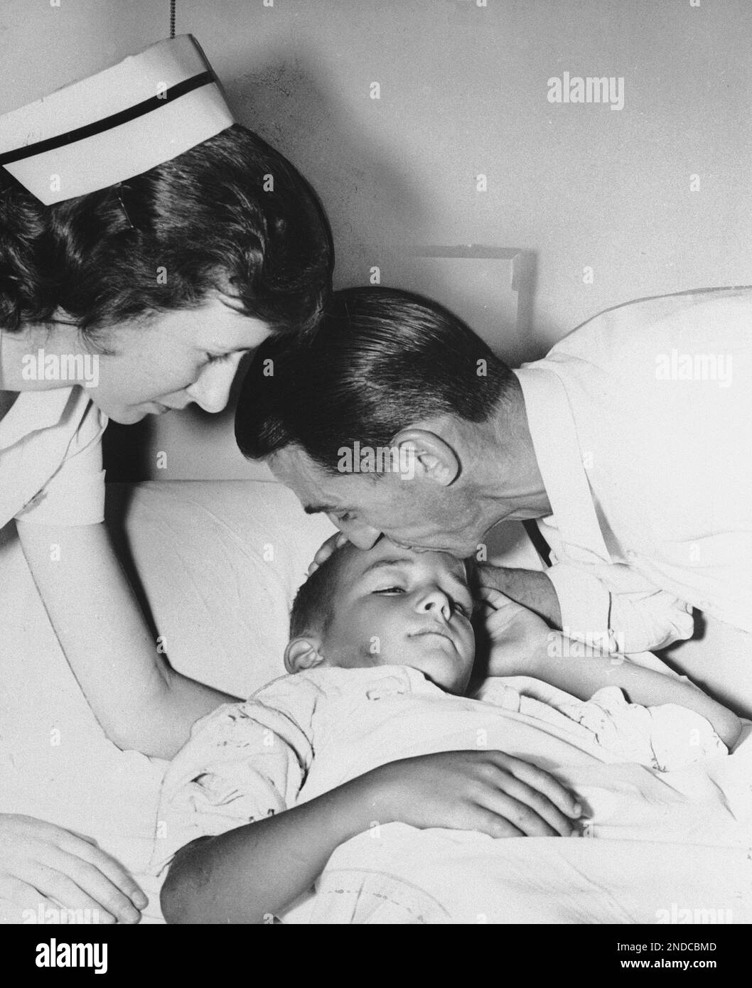 Seven year old Roger Woodward is given a kiss on the forehead by his ...