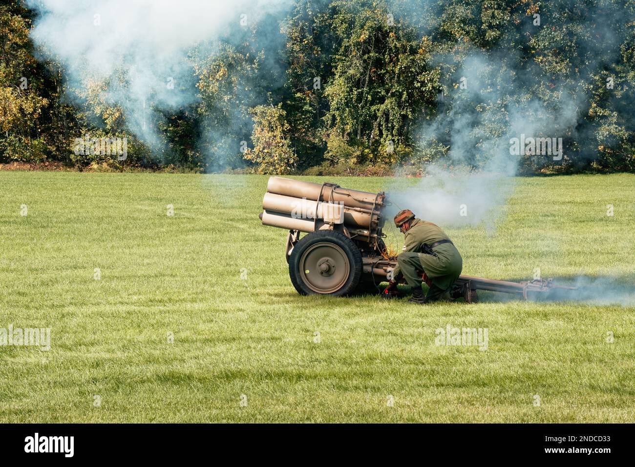 A German mortar fires at American troops on the WWII battlefield during ...