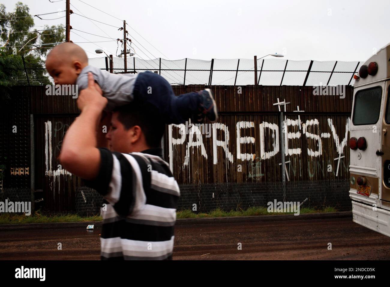 Gilberto Perez carries his 8-month-old newphew Adan Estrada as they ...