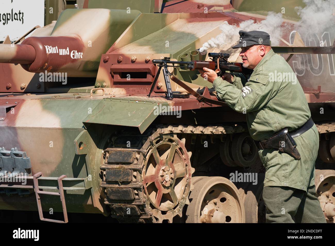 A German soldier fires at American troops from the side of a vintage ...