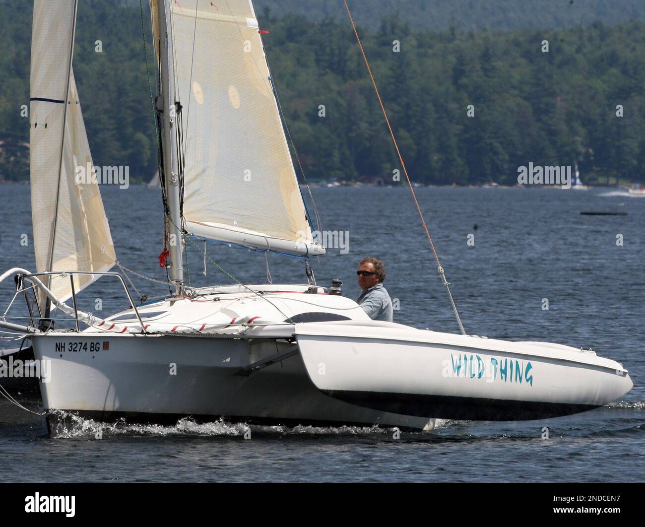Peter Duby rides the summer breeze as he sails on Lake Sunapee in ...