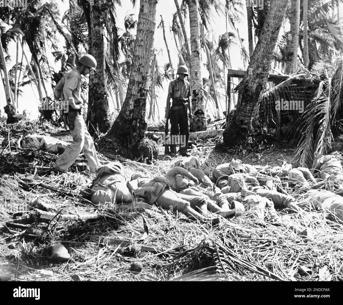 Coast Guardsmen from one of the invasion barges which took troops to ...