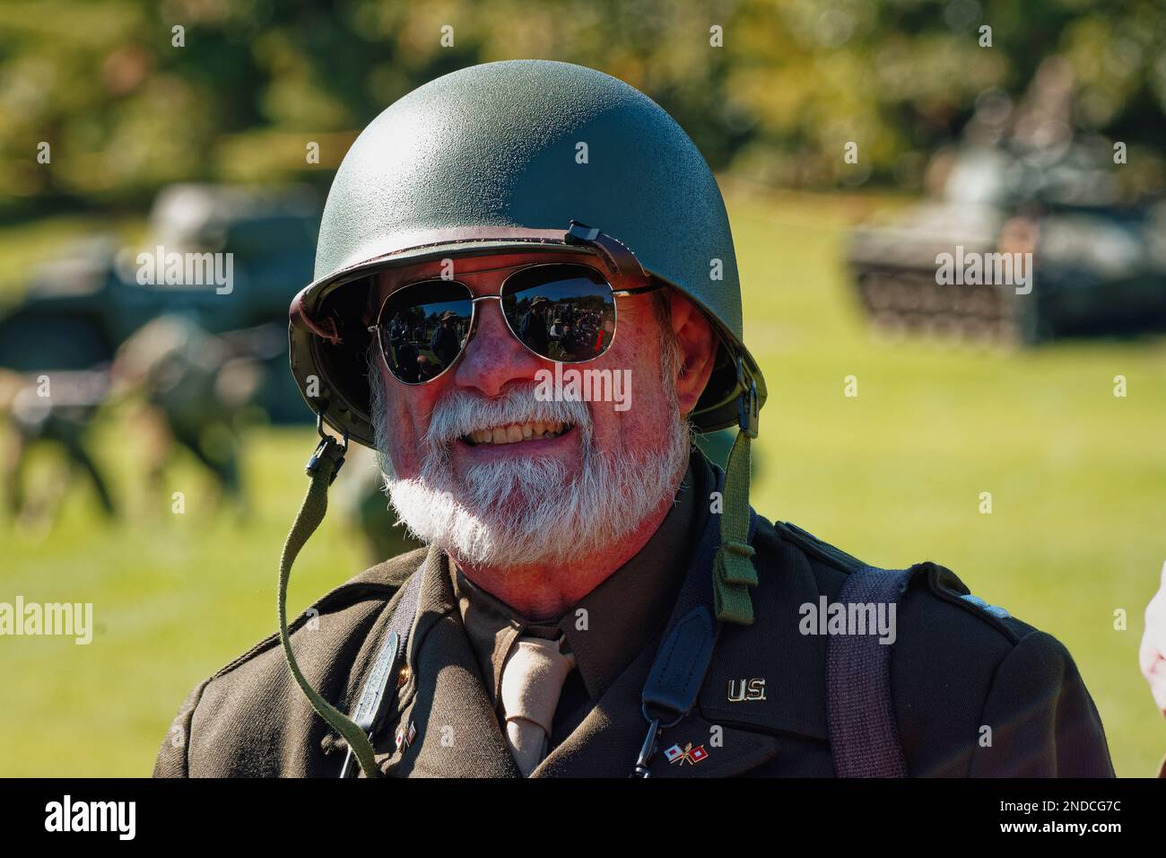 An American Captain wearing a metal helmet on the battlefield during a ...
