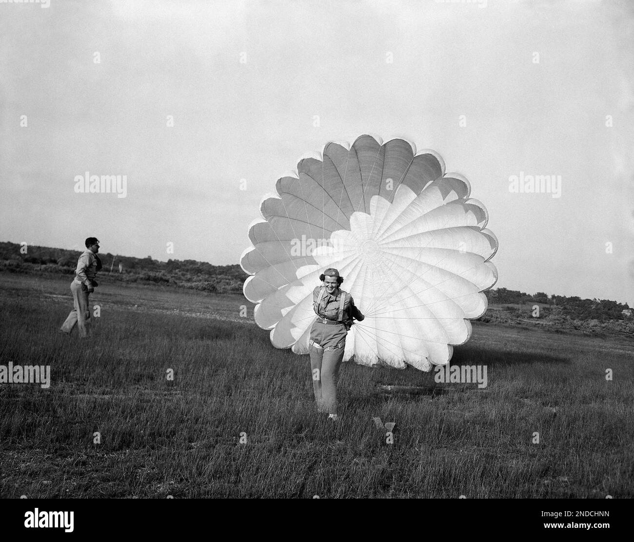 Ann Cutler, 22, of Needham, Mass., pulls on the cords of her parachute ...