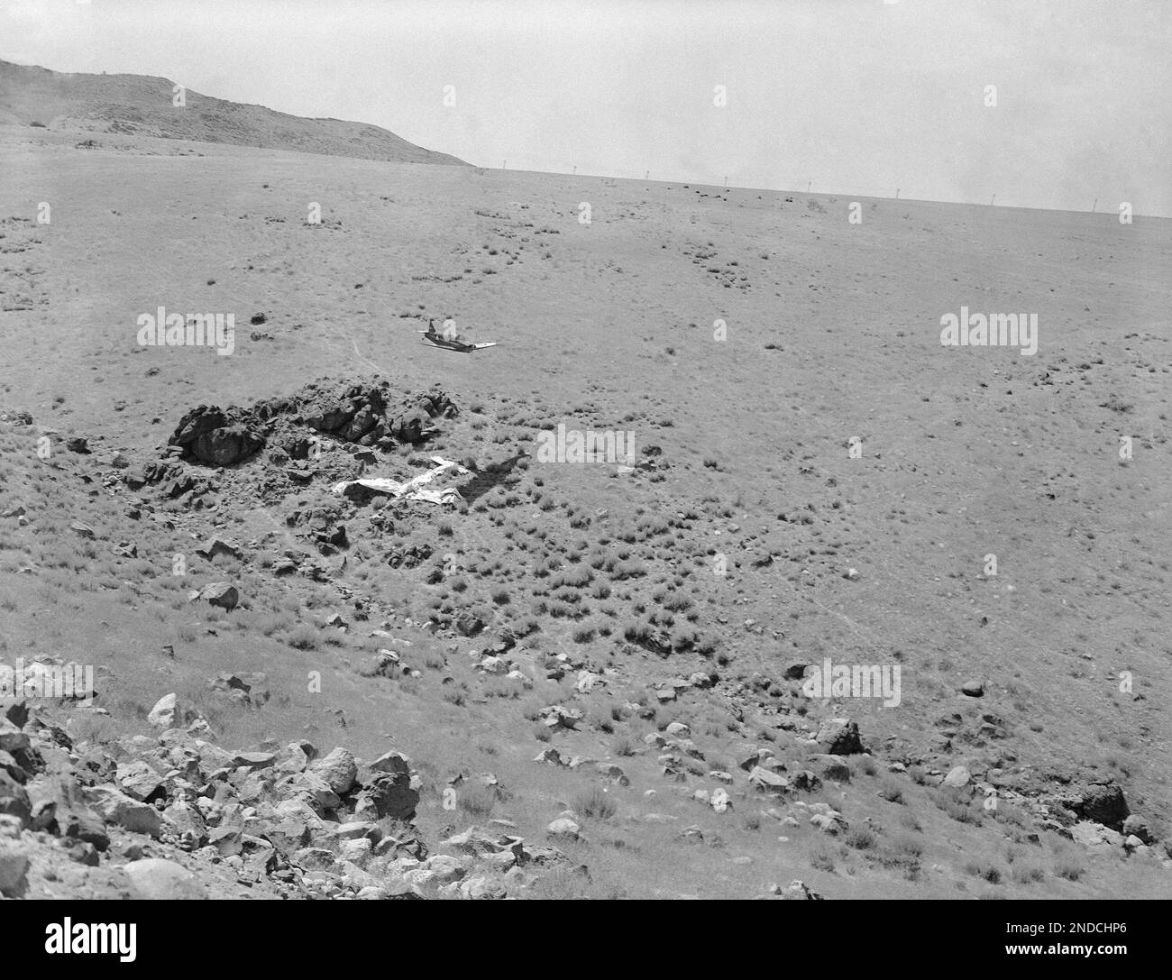 Roaring over rugged terrain this CAP plane locates a simulated bomber ...