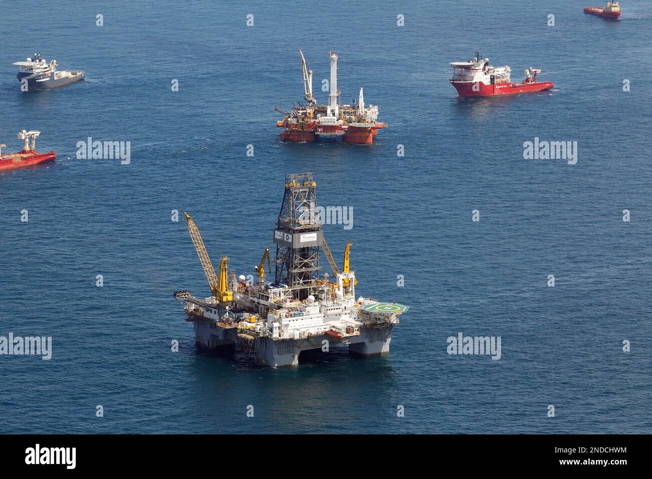 The Transocean Development Driller III, foreground, which is drilling ...