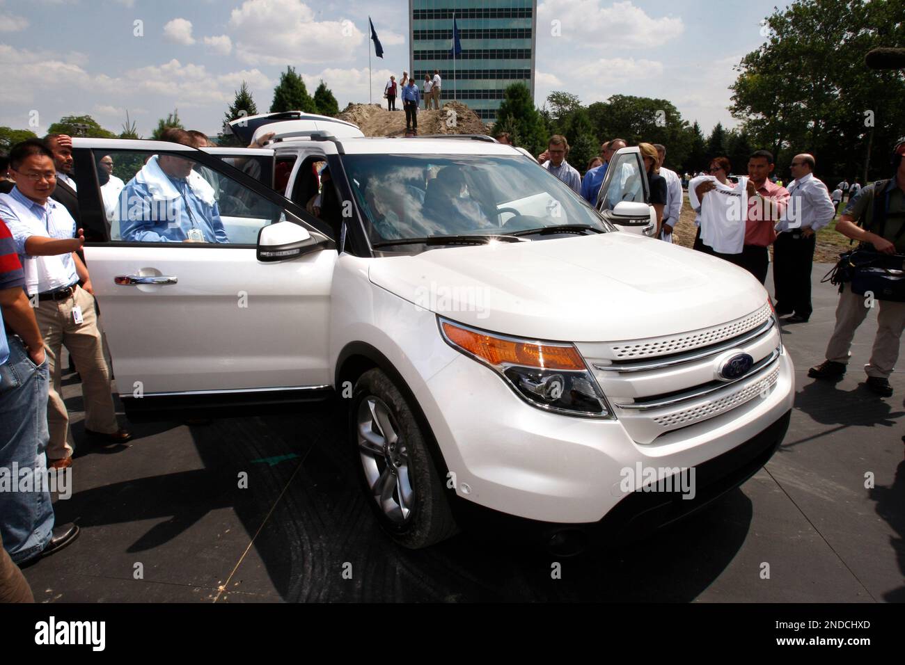 Ford employees look over the 2011 Ford Explorer at the Ford world ...