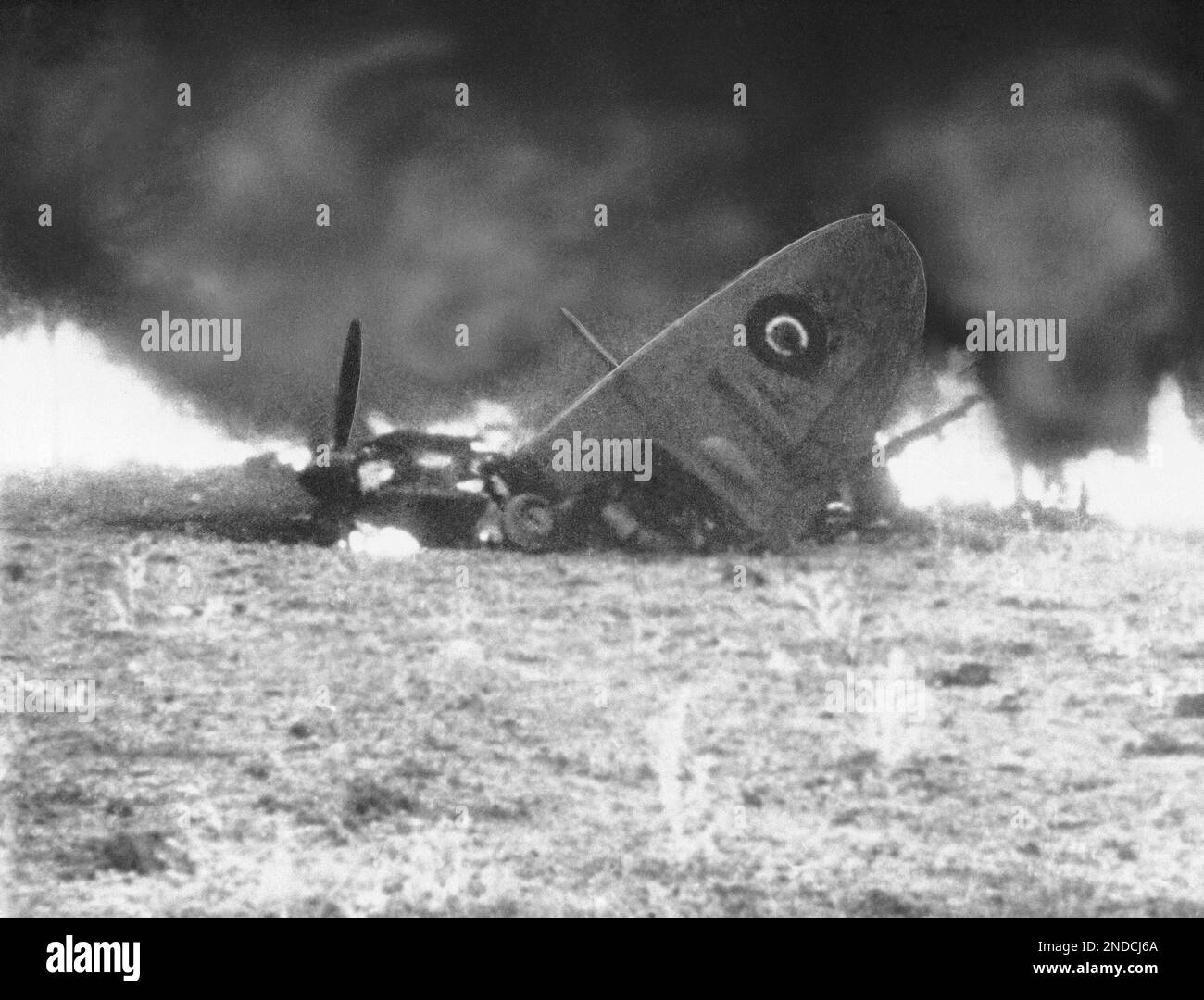 Fire and smoke from a backdrop to this wrecked Allied plane as it lay ...