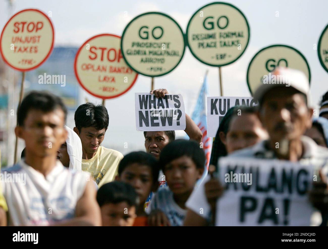 Activists hold slogans in reaction to Philippine President Benigno ...