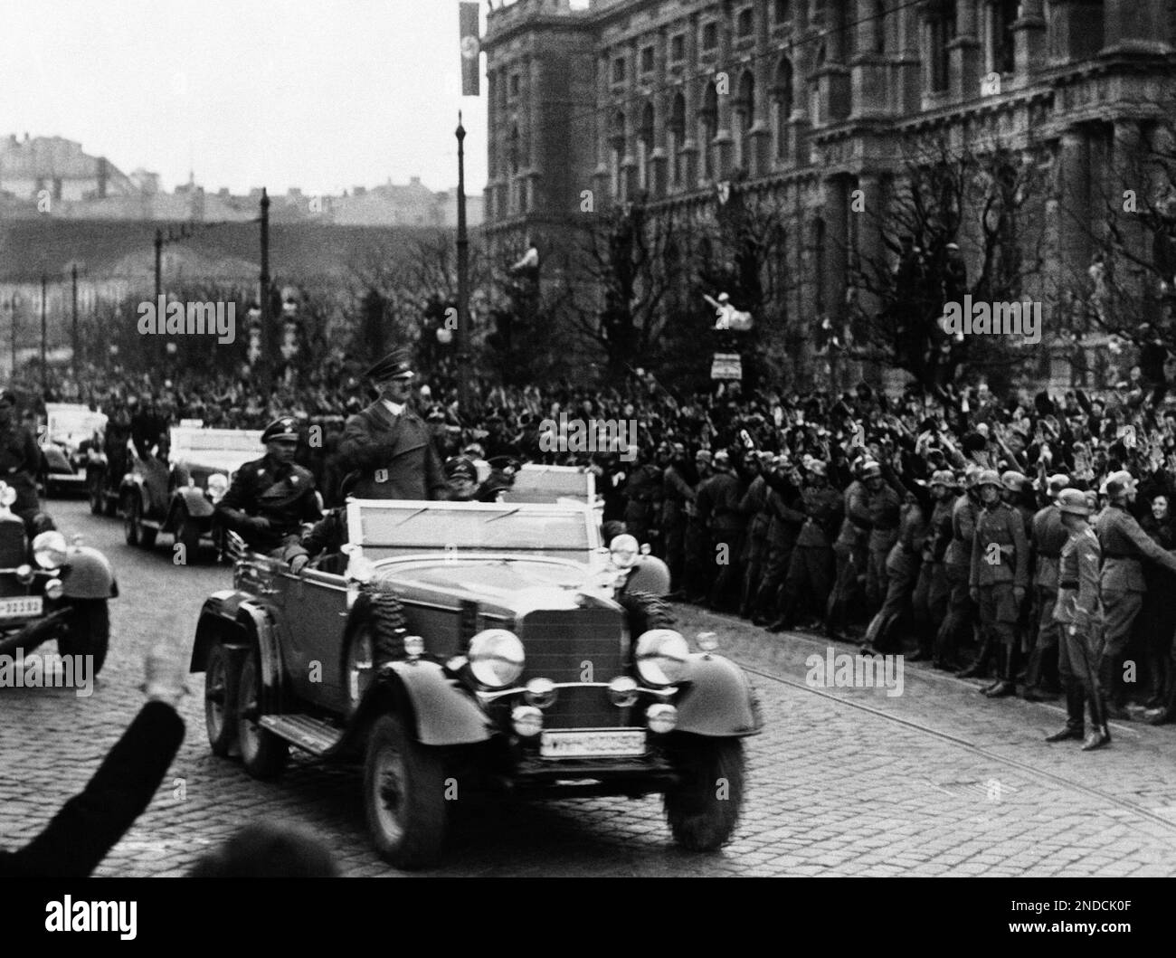 Standing upright in an open Grey-Green car, German Chancellor Adolf ...