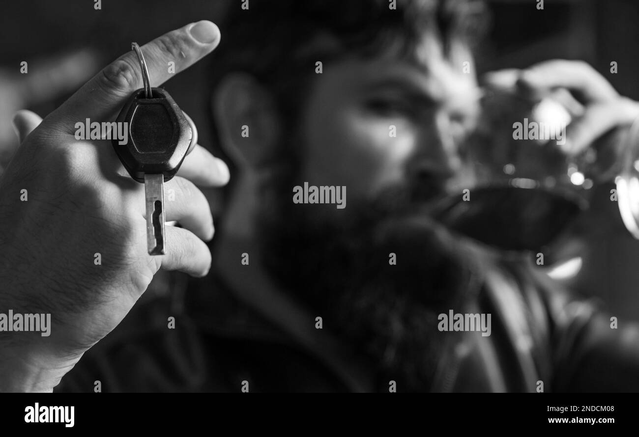 Confident macho man drinking whiskey and holding his car keys. Luxury ...