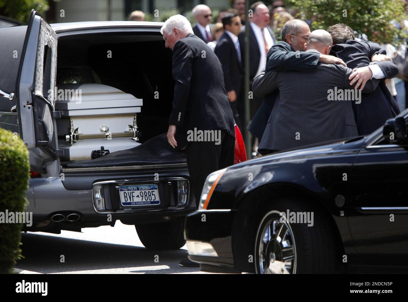 FILE - In this file photo of July 30, 2009, a group of men hug as ...